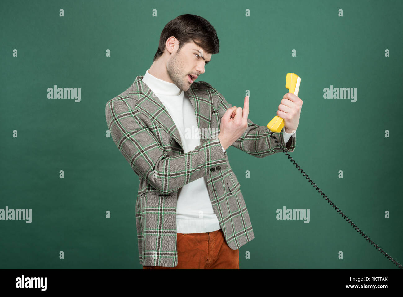 angry handsome man in vintage clothes showing middle finger in front of ...