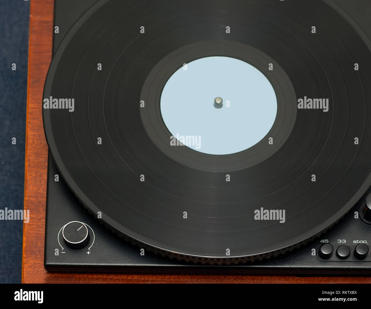 Part of vintage record player with wood finish with black LP vinyl ...