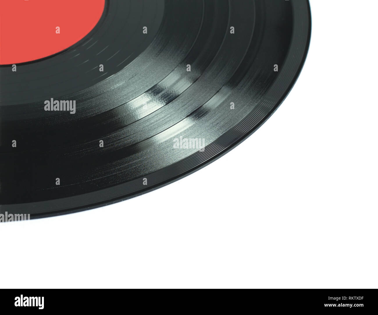 Black long-play vinyl record segment with red label isolated on white ...