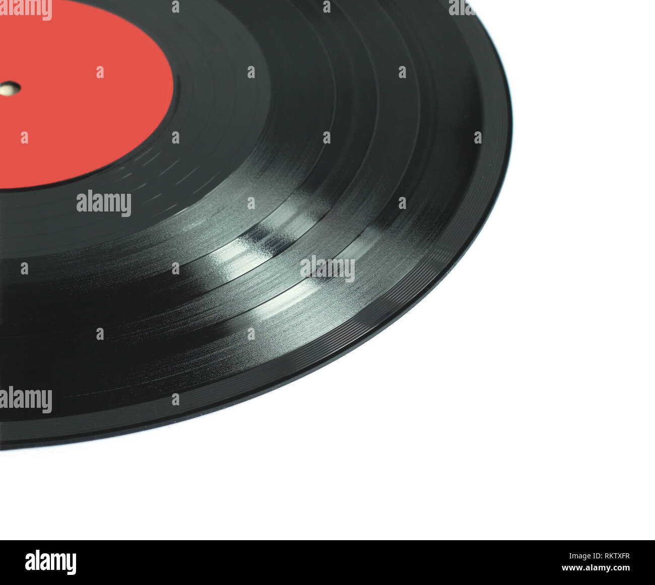 Part of black long-play vinyl record with red label isolated on white ...