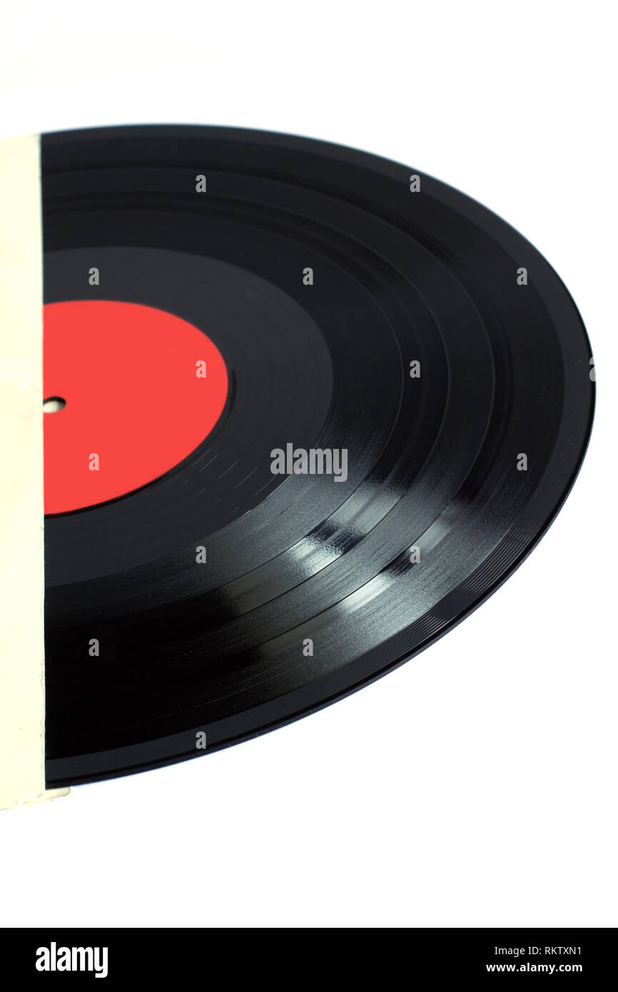 Black long-play vinyl record segment with red label isolated on white ...