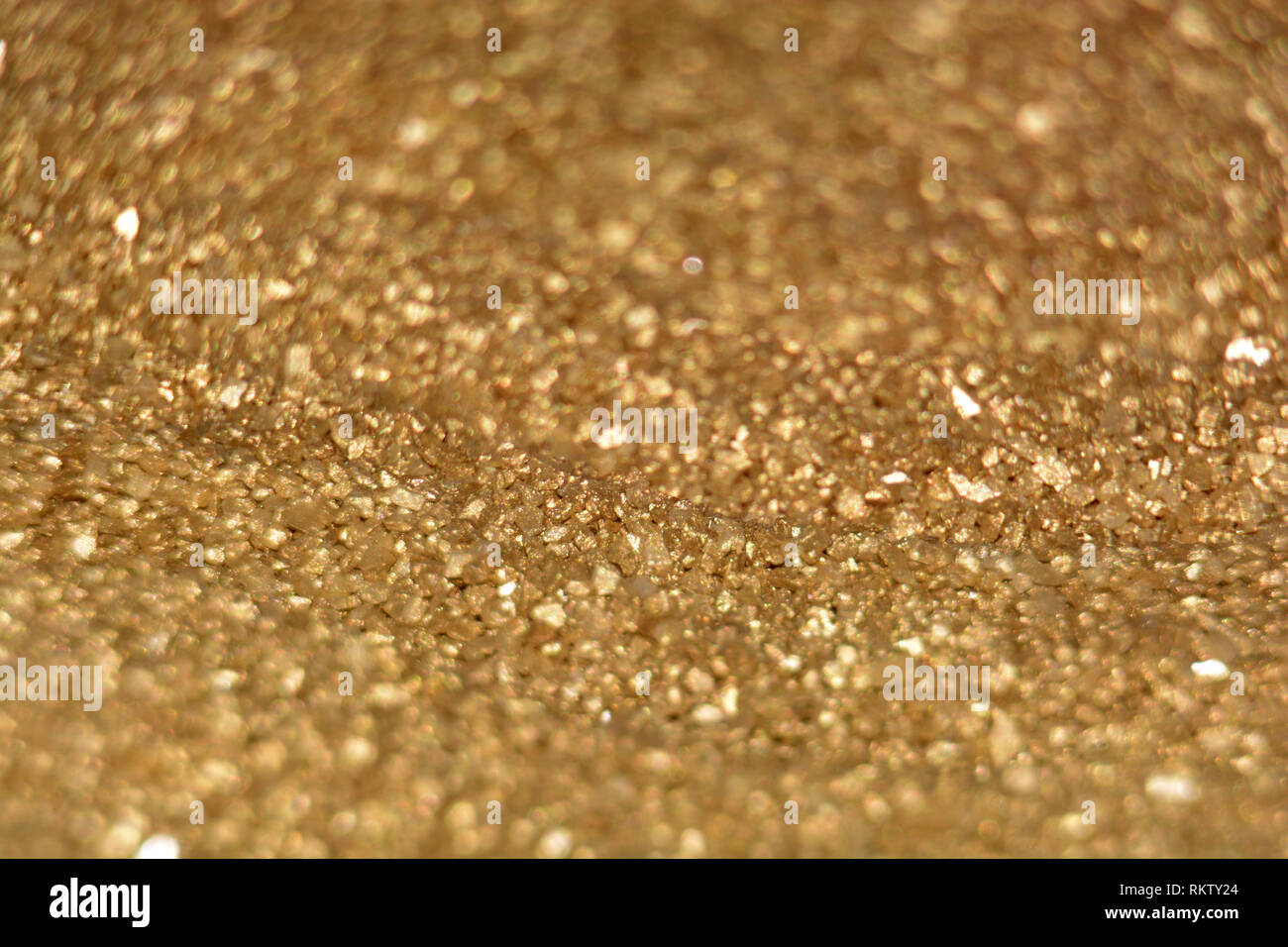 golden glitter texture with light reflections, defocused golden glitter ...