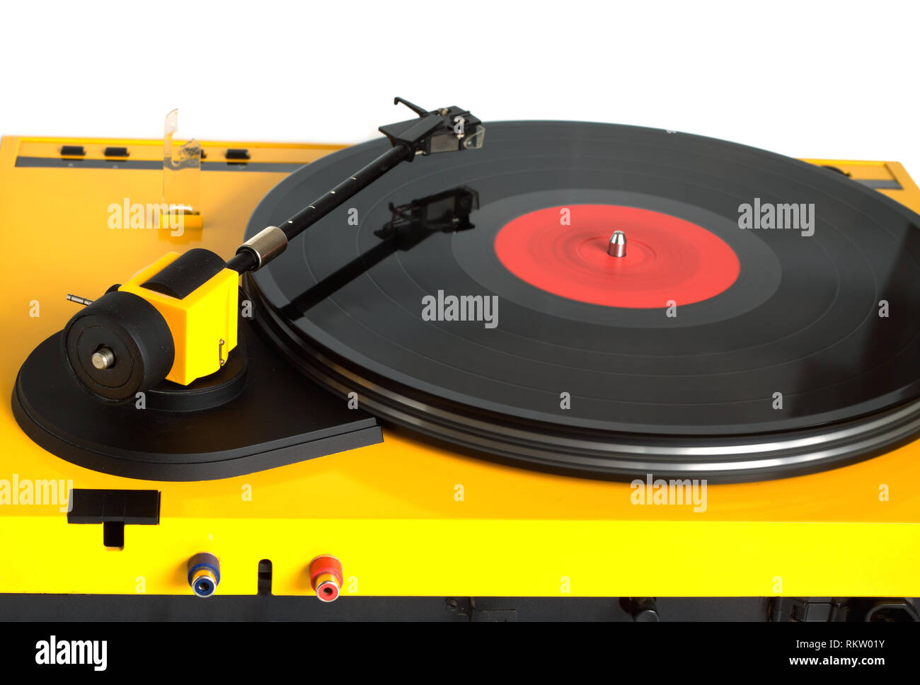 Turntable in yellow case with rotation vinyl record with red label ...