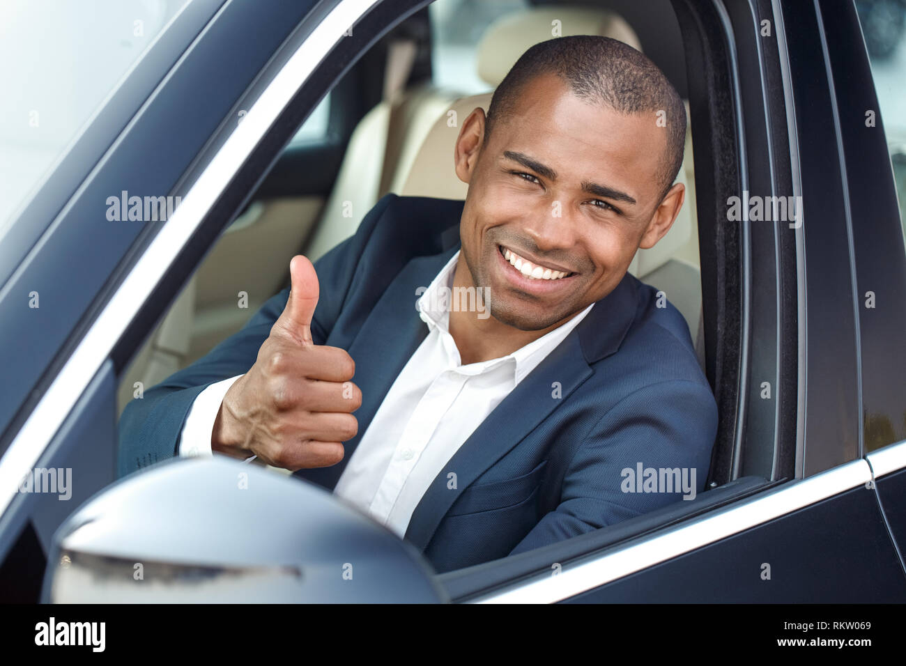 Young african american businessman driver sitting inside the car ...