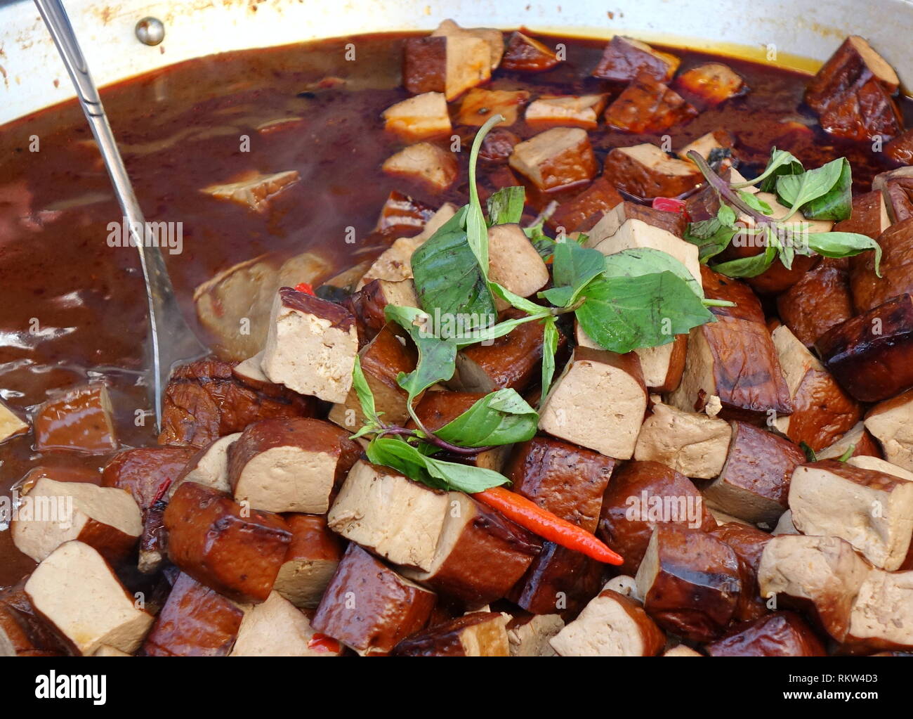 Pressed bean curd with chilies and fresh basil Stock Photo - Alamy