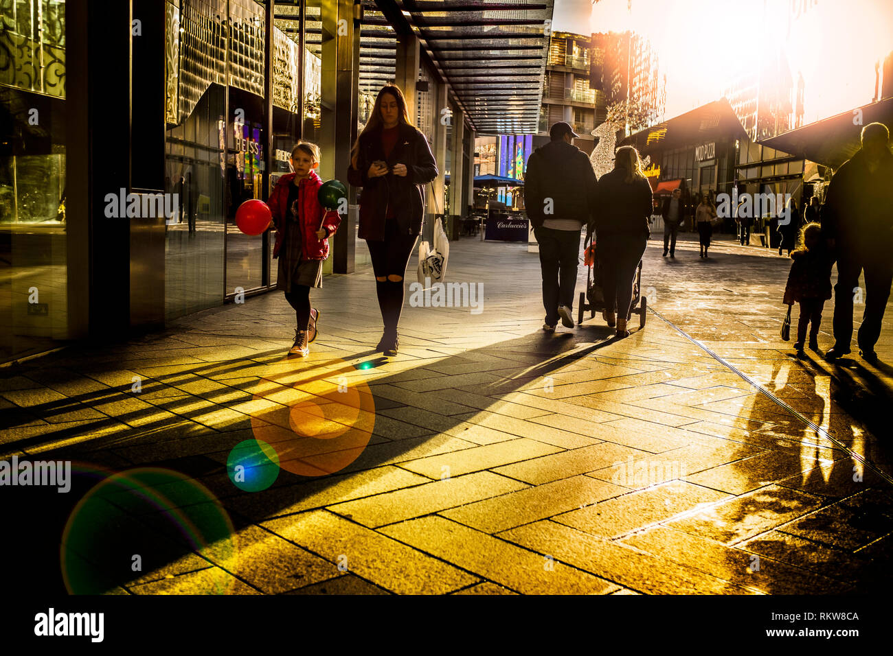 A low winter sun casts heavy shadows in a city street Stock Photo - Alamy