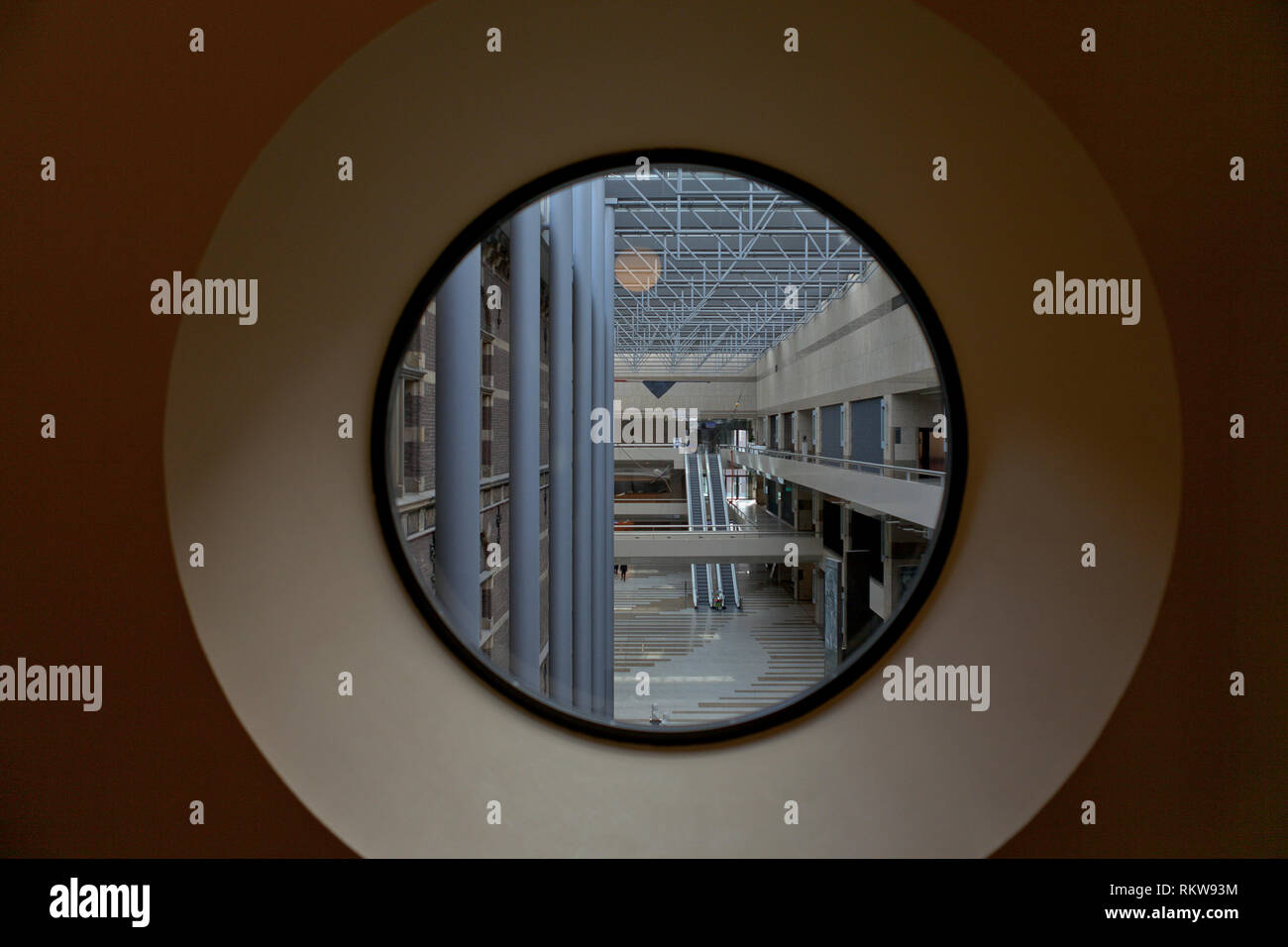 Peaking through a round window looking unto the interior corridor in ...