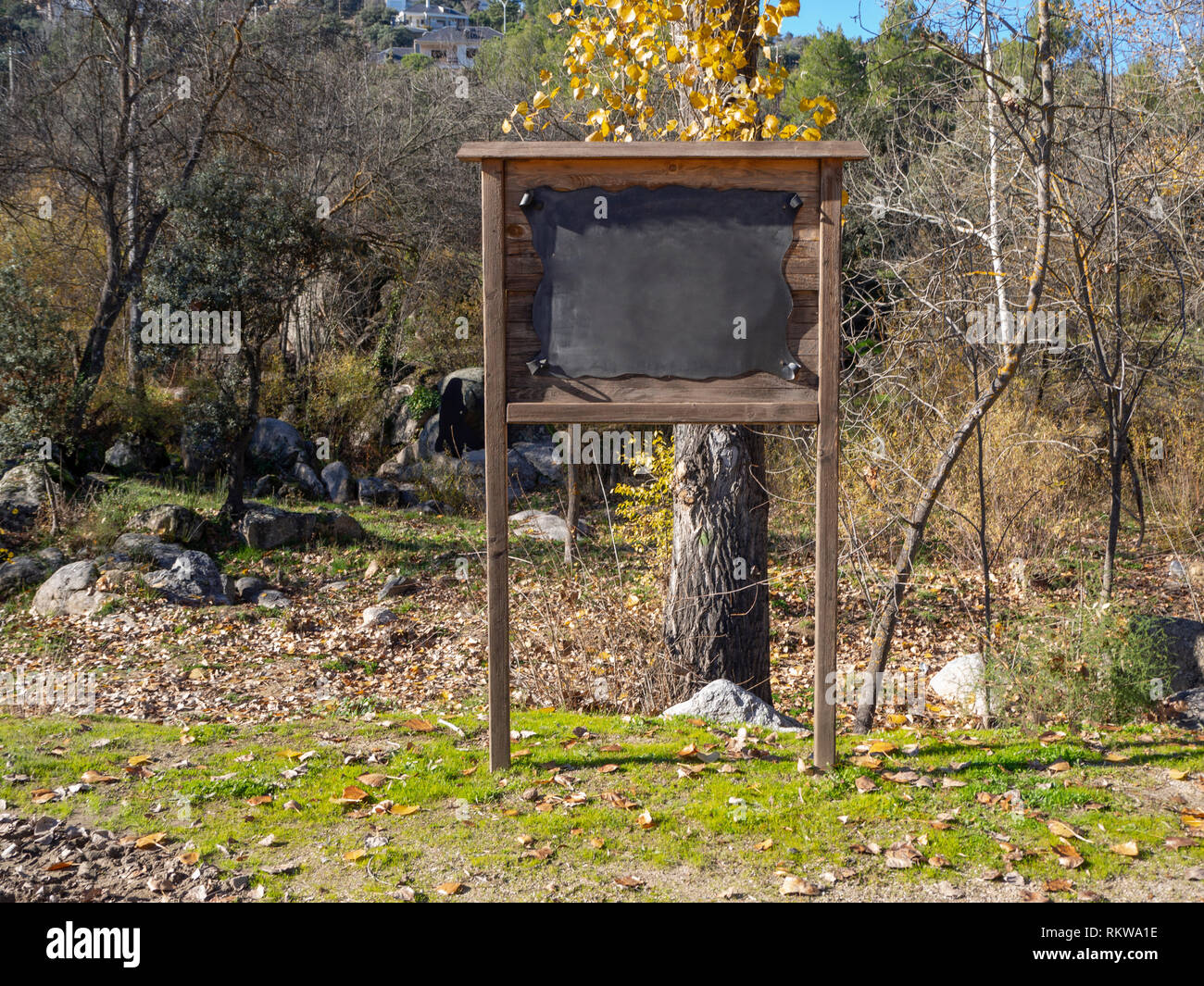 Wooden sign, rustic and weathered, on two posts, detached in the ...