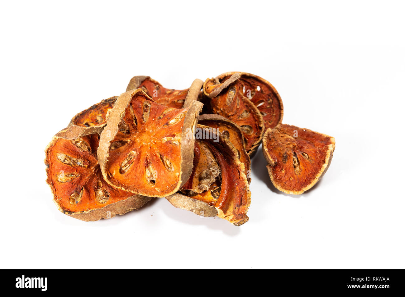 Slices of dried bael fruit on white background Stock Photo - Alamy