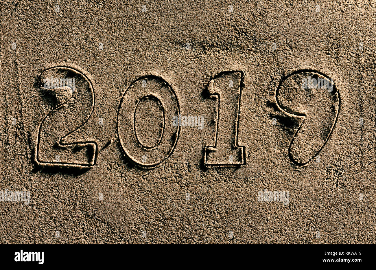 The year 2019 cut into wet sand Stock Photo - Alamy