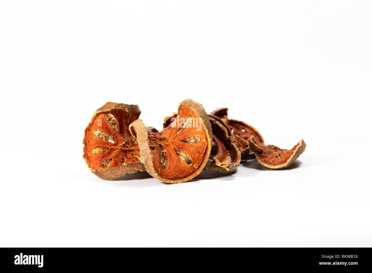 Slices of dried bael fruit on white background Stock Photo - Alamy