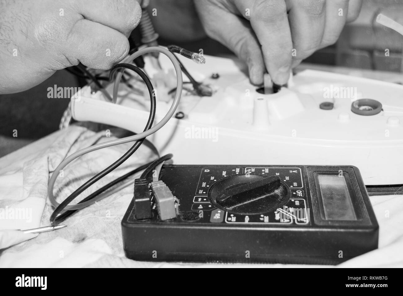 Black and white photo, close-up of the old electrician's hand, the use ...