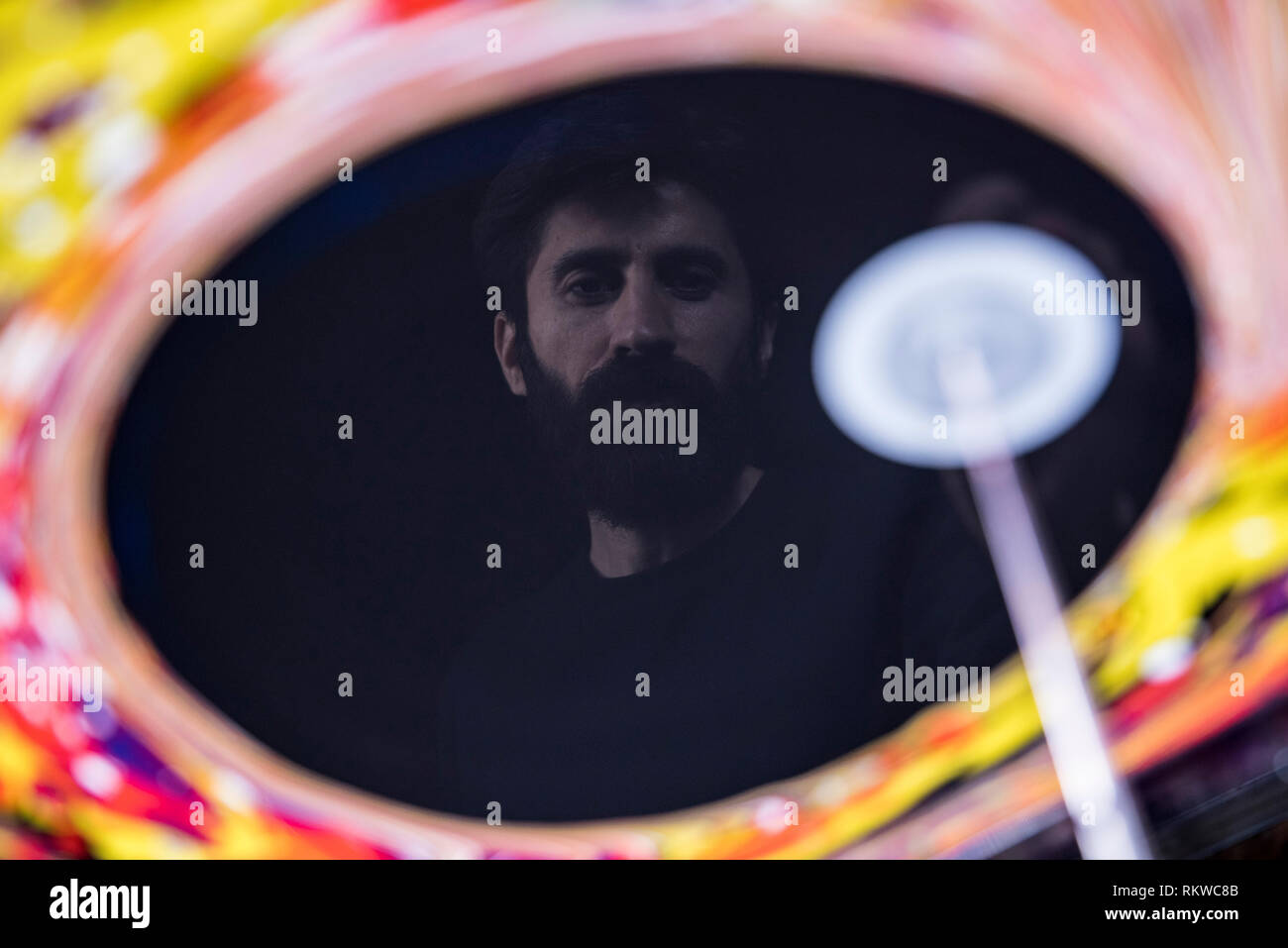 Reflection of Garip Ay, an Ebru artist, while drawing figures in the ...