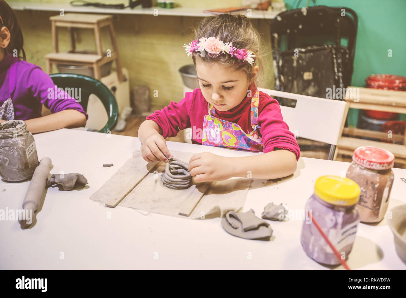 Child pottery workshop, little girl working with clay, creative ...