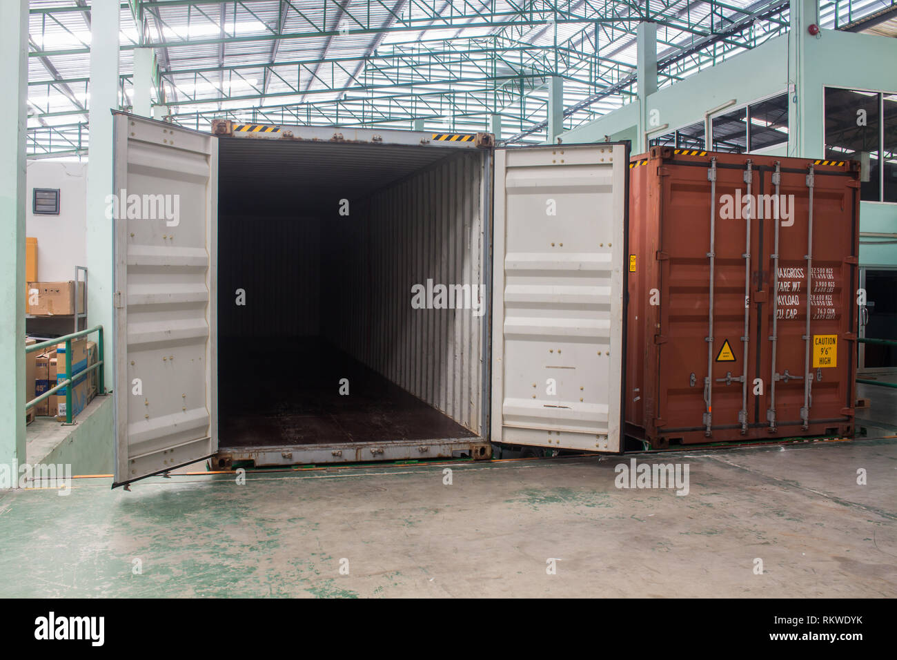 The empty container inside warehouse on shipment area Stock Photo - Alamy