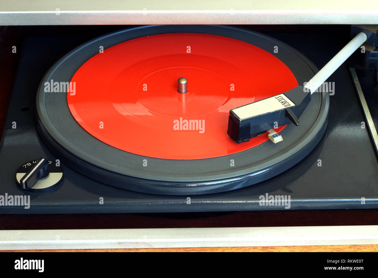 Old vintage record player playing red flexible disc. Horizontal top ...