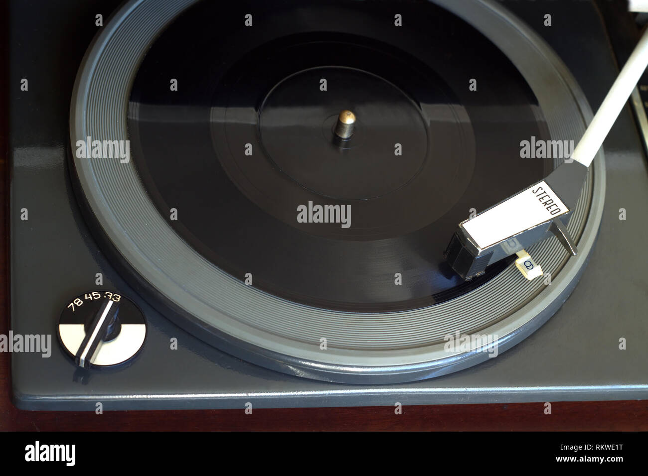 Old vintage record player playing black flexible disc. Horizontal top ...