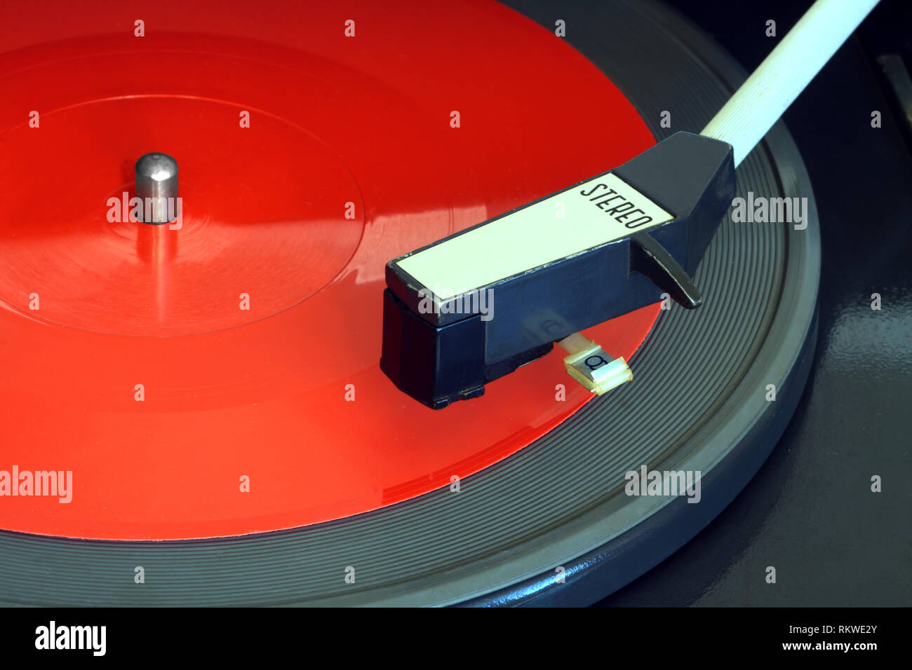 Old vintage record player playing red flexible disc. Horizontal top ...