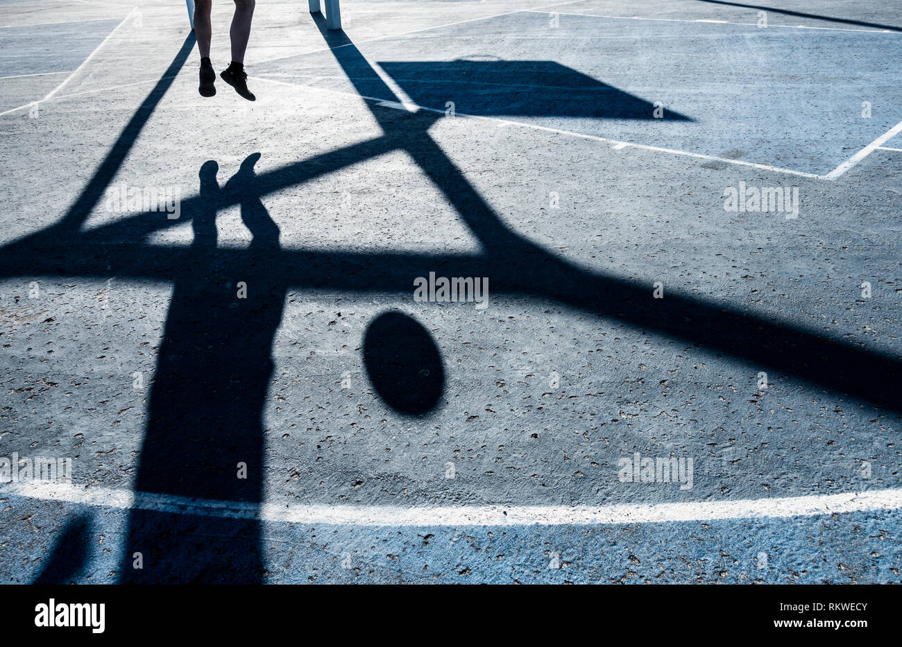 Long shadows on basketball court Stock Photo - Alamy