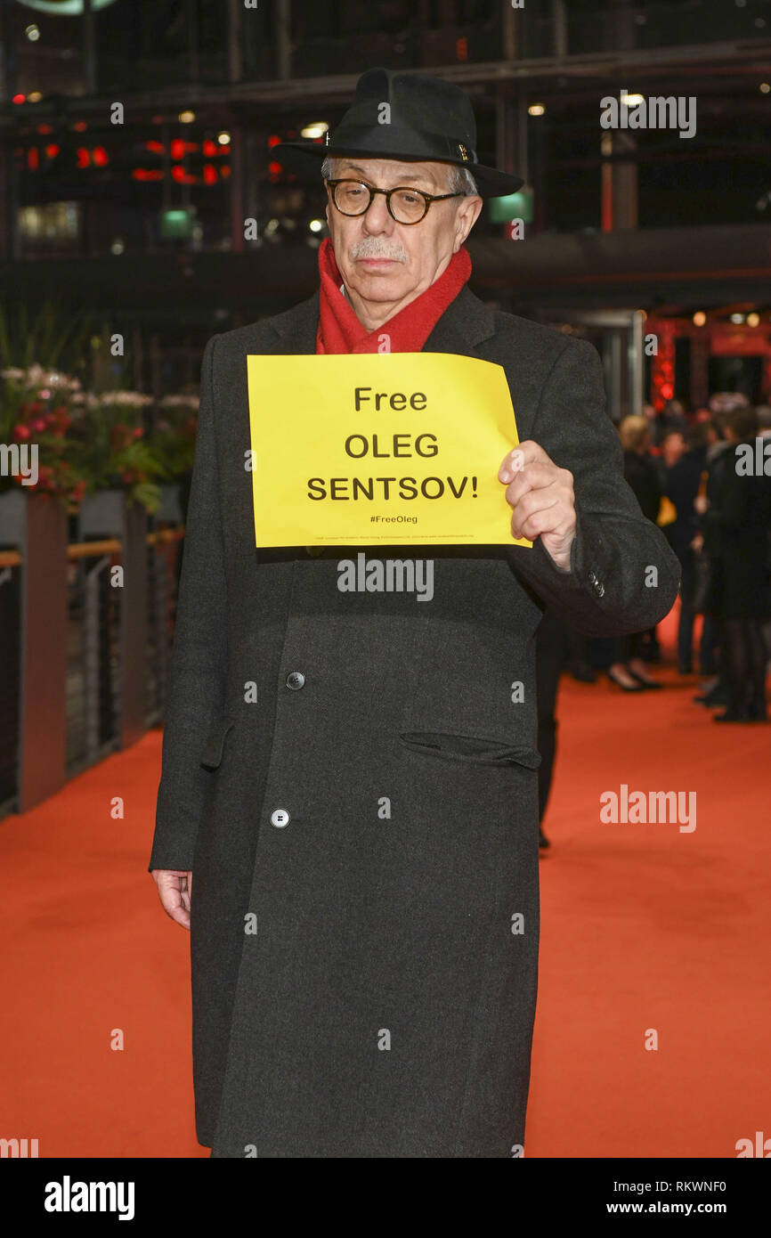 Dieter Kosslick holds a sign reading Free Oleg Sentsov at the premiere ...
