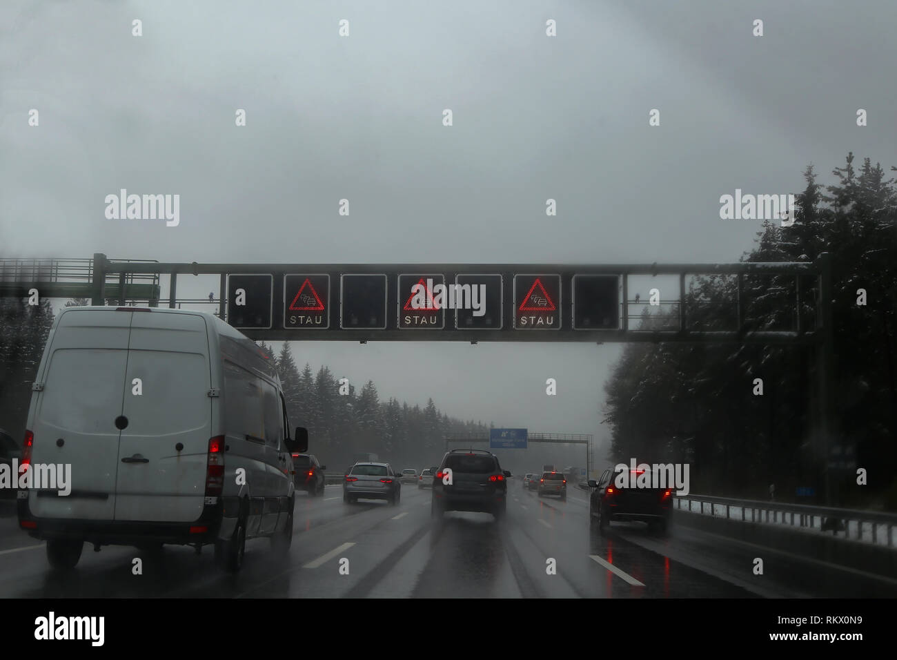 Bad weather on the Autobahn / Text on signs in German: traffic jam ...