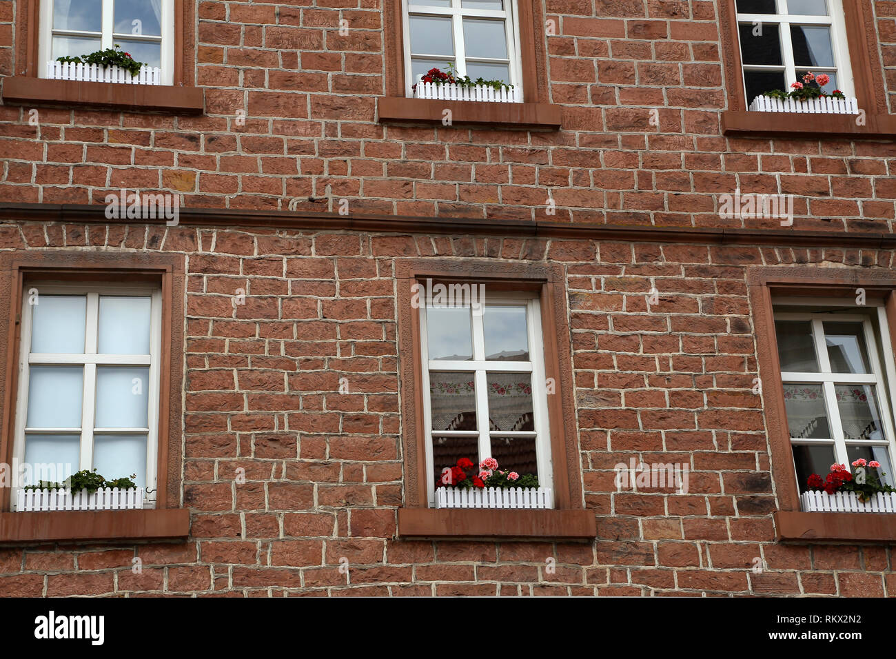 Brick wall of a house with windows Stock Photo - Alamy