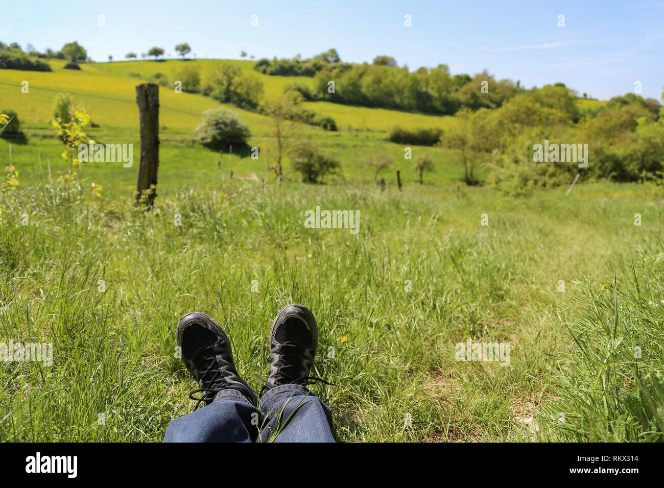 The feet of a traveler against the background of a beautiful summer ...