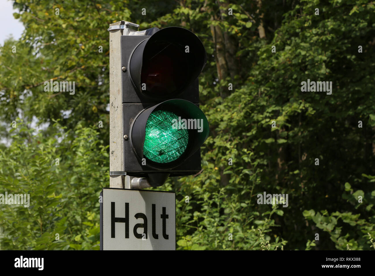 Green / Traffic light installed at the crossroads Stock Photo - Alamy