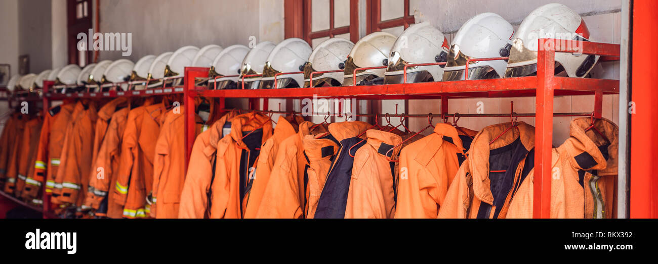 Close up of Fireman coats, helmets and boots wait for the next call ...