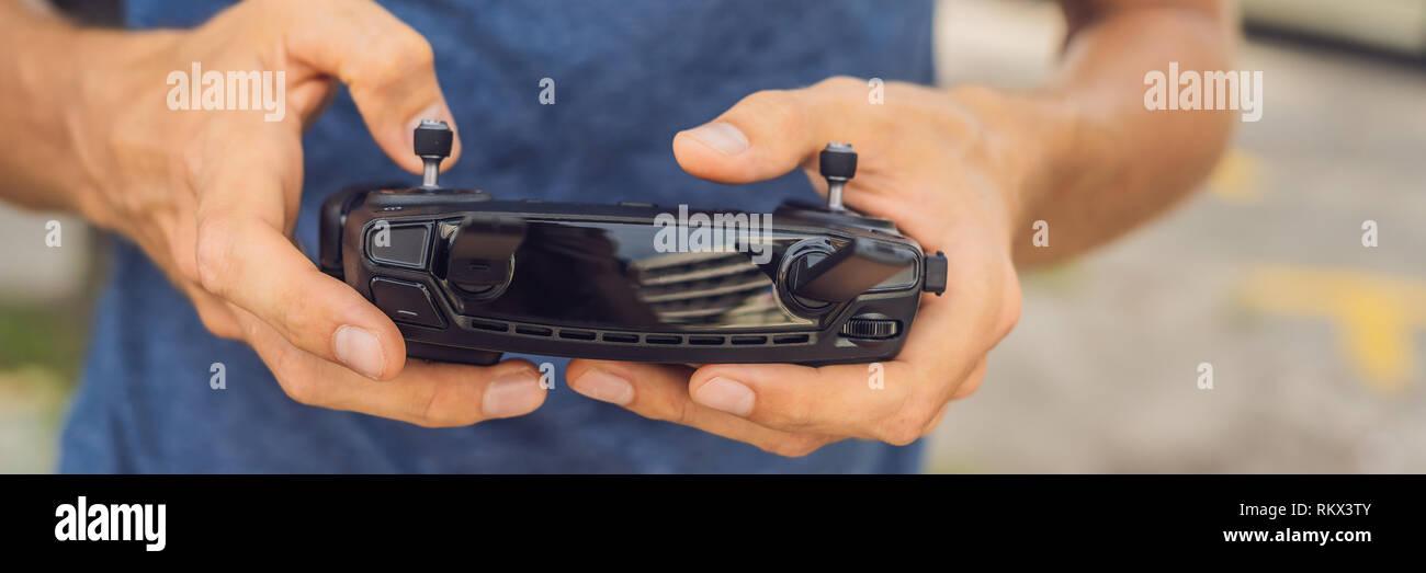 Man holds remote controller with his hands and controls the drone. New ...
