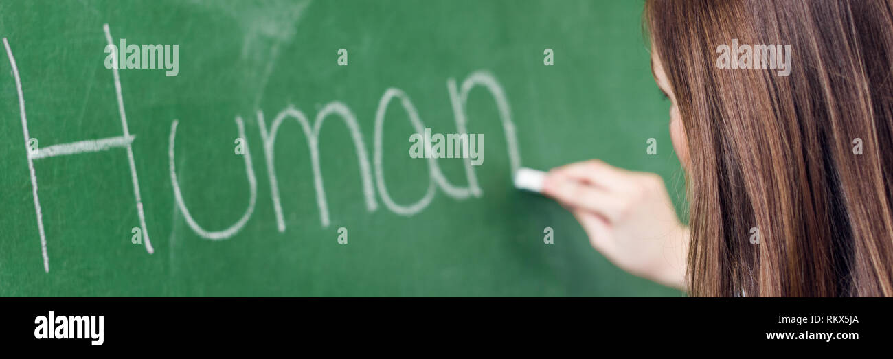 Young female teacher teaching in biology class. Teacher writing Human ...
