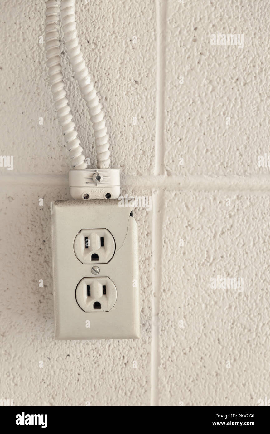 Old rustic North American electrical outlet on a white brick wall Stock ...