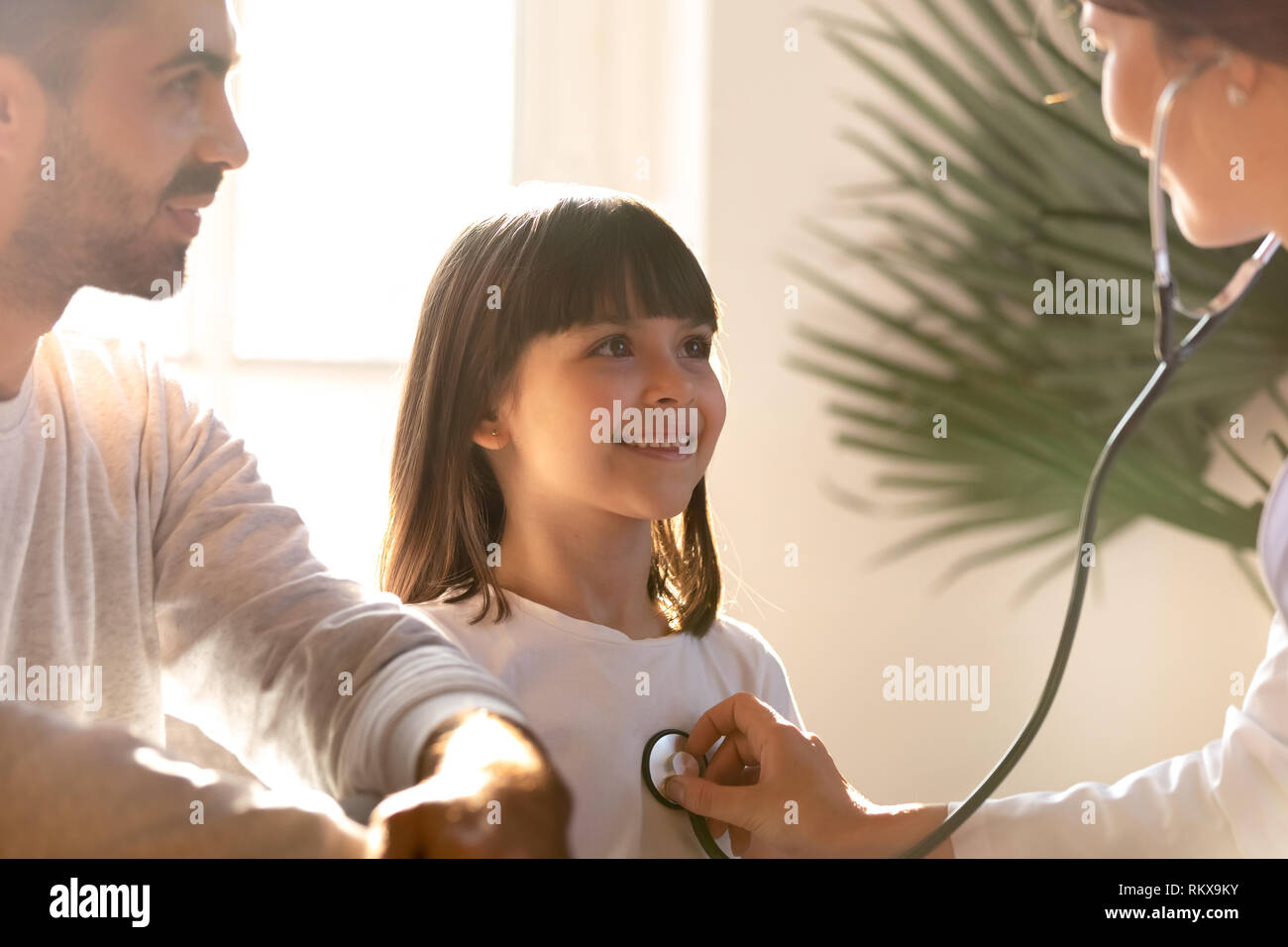 Female pediatrician holding stethoscope examining child visiting doctor ...