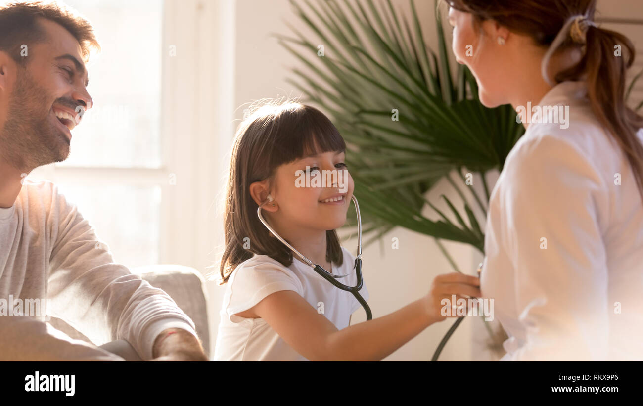 Cute playing doctor visiting pediatrician while doctor and dad laughing ...