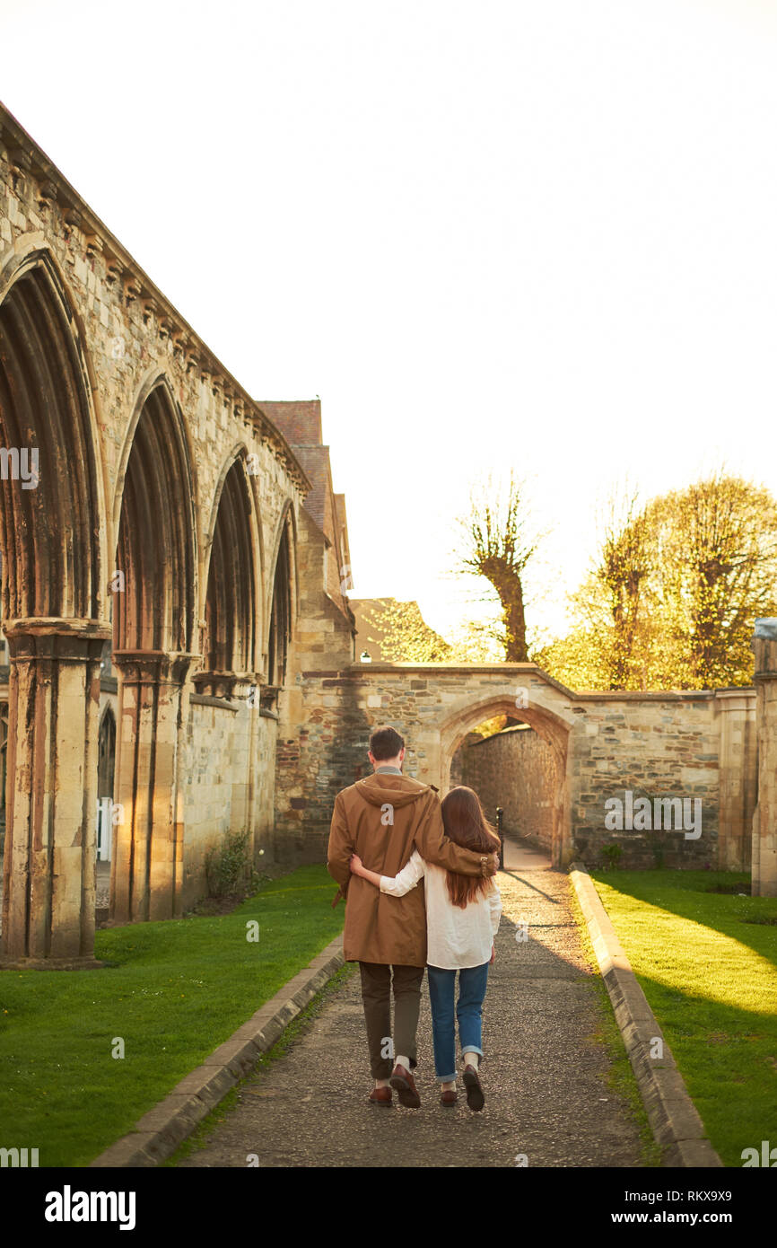 Rear view of a silhouette of a loving couple, hugging while visiting a ...