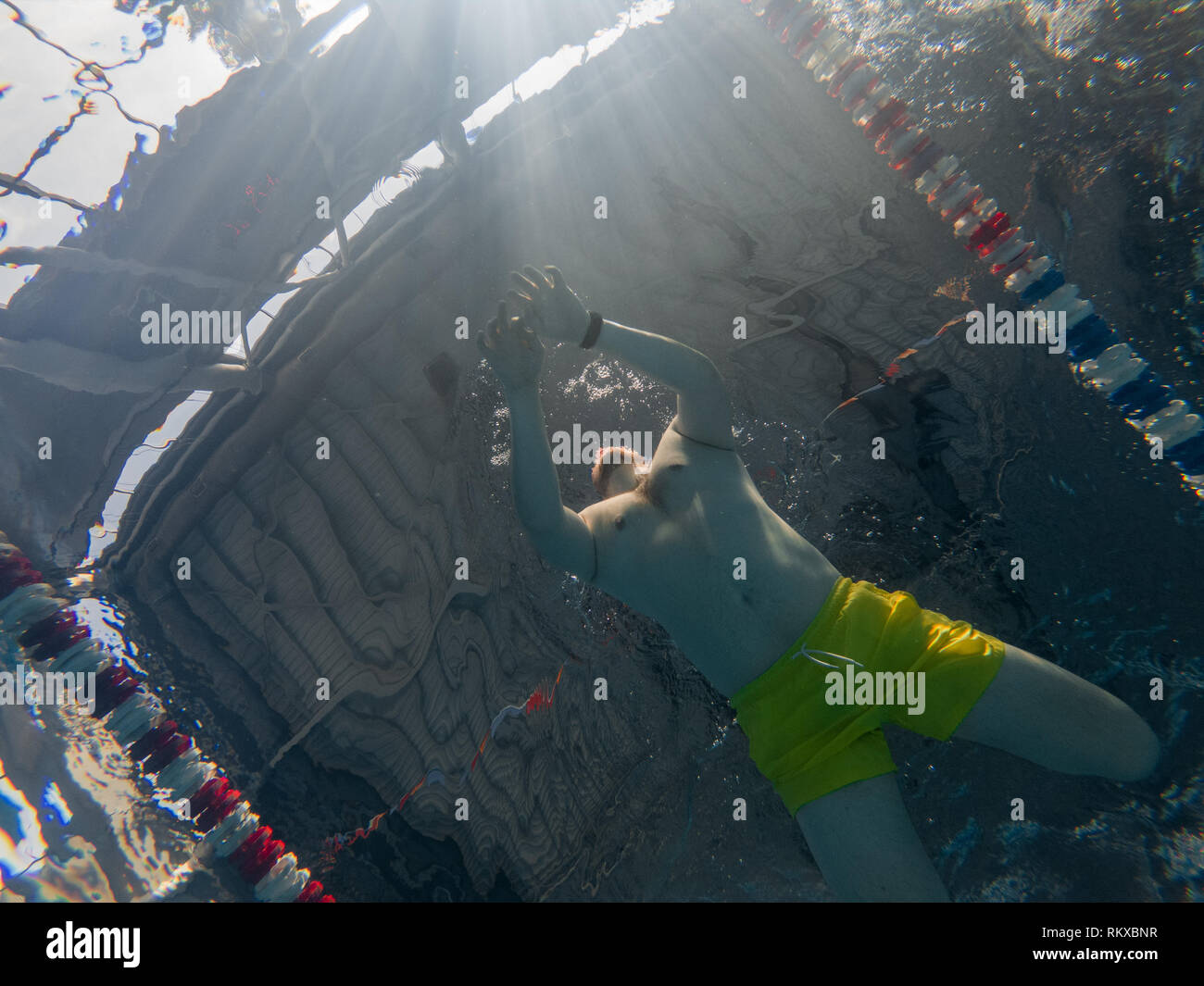 people swimming in pool view from the underwater. sporty lifestyle ...