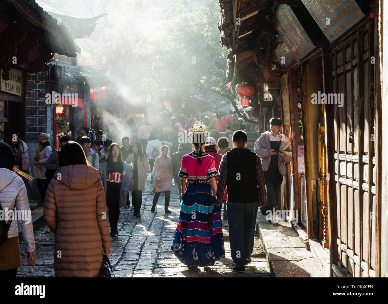 Girl in traditional clothing walking in Lijiang old town, Yunnan, China ...