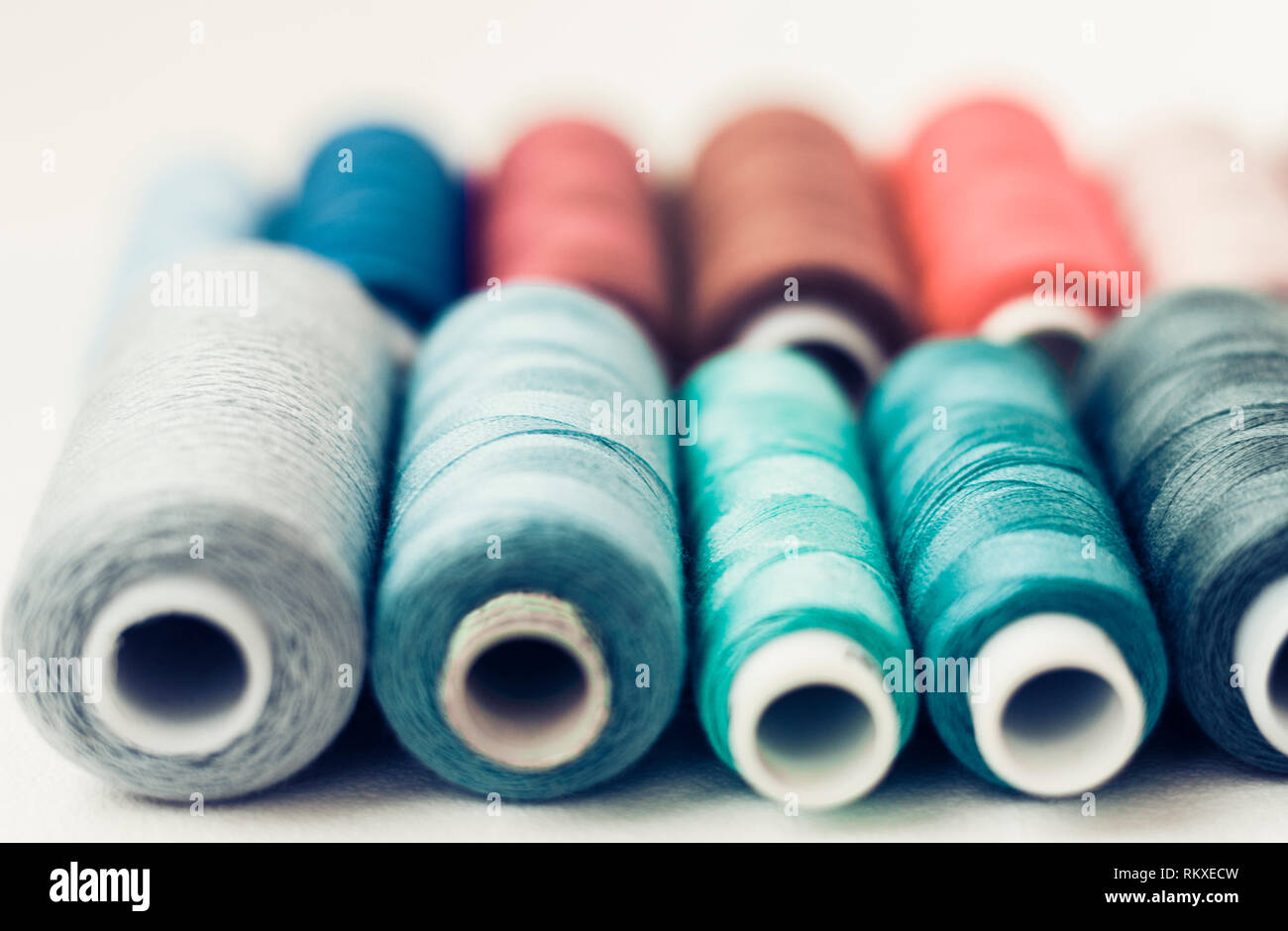 Colored sewing thread coils on white background with copy space for ...