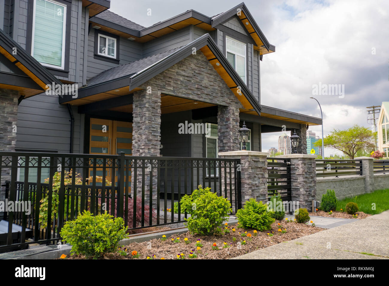 Luxury residential house with front behind metal fence. Big family ...