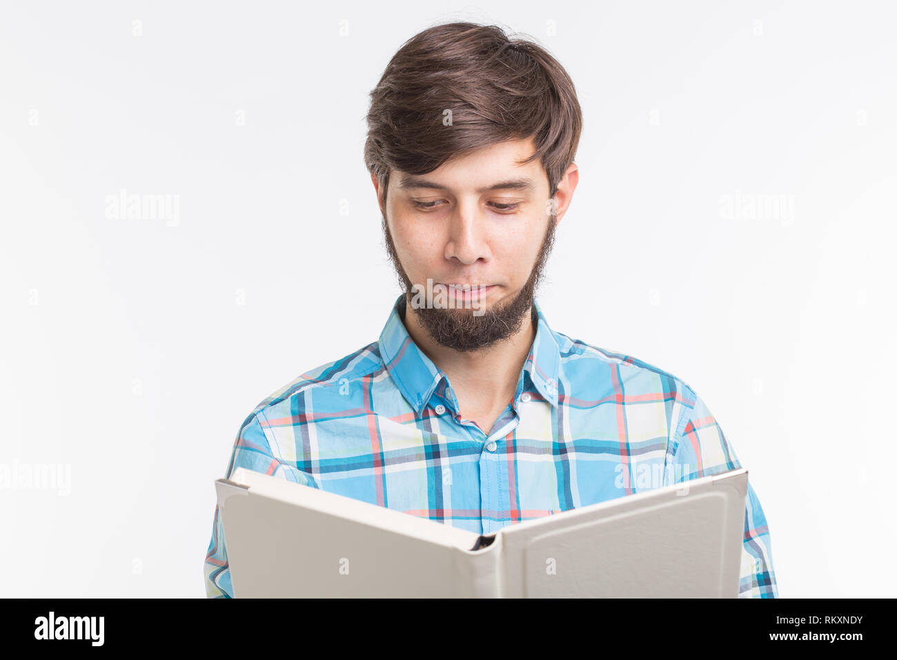 Education, process and people concept - young man reading a book ...