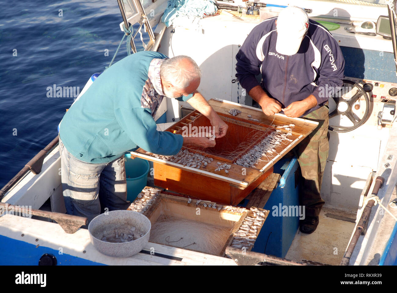 before leaving from the port on the boat fishermen prepare a longline ...