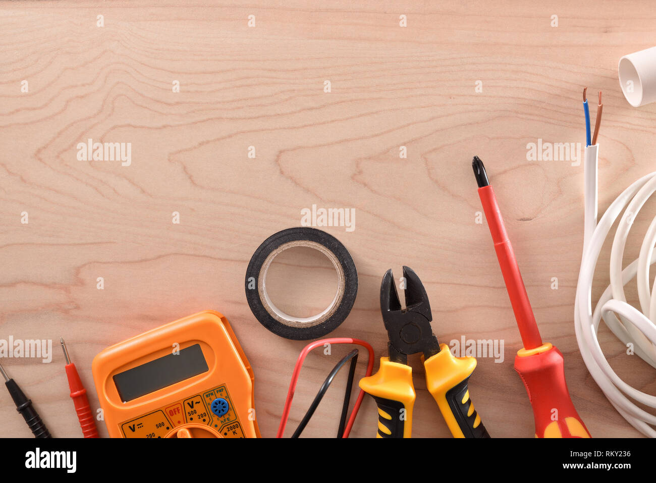 Variety of electricity tools on a wooden table with space above close ...