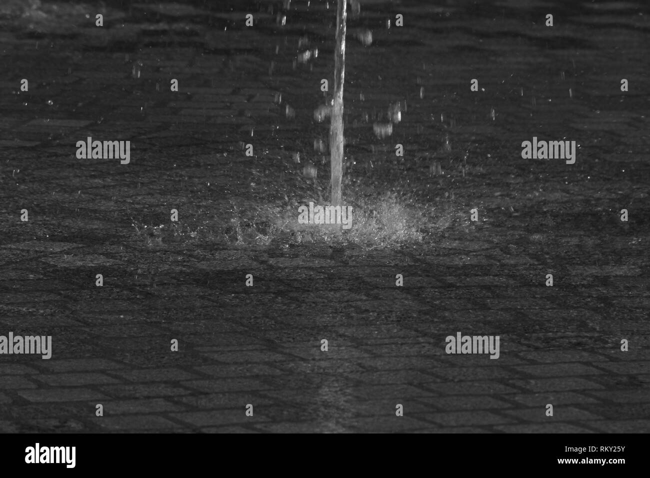 Water droplets hitting surface from street fountain Stock Photo - Alamy