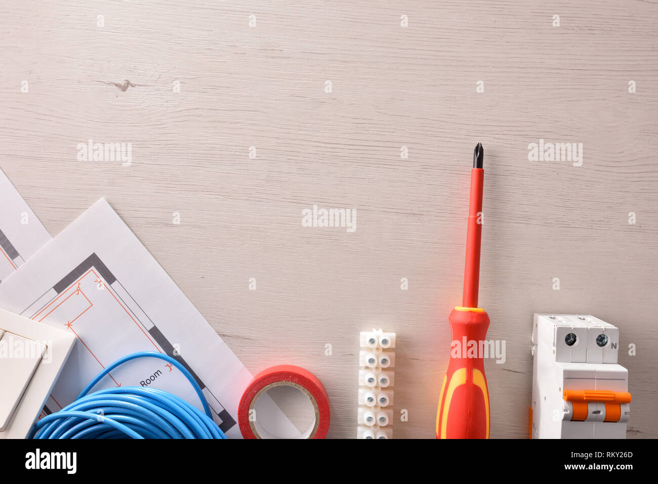 Equipment on white wooden table for electrical installation of housing ...