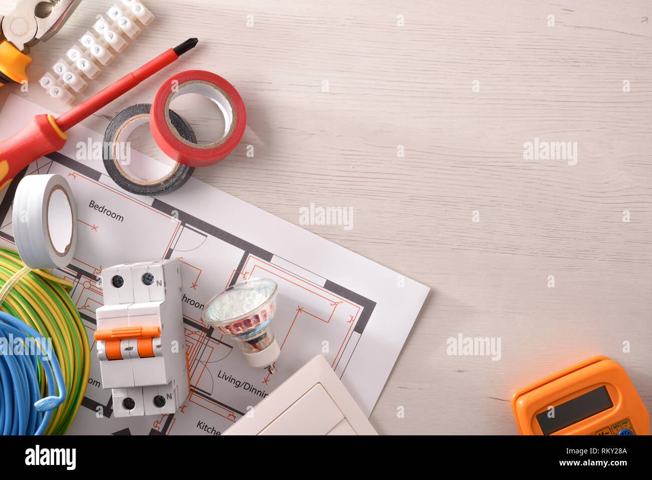 Equipment on white wooden table for electrical installation of housing ...