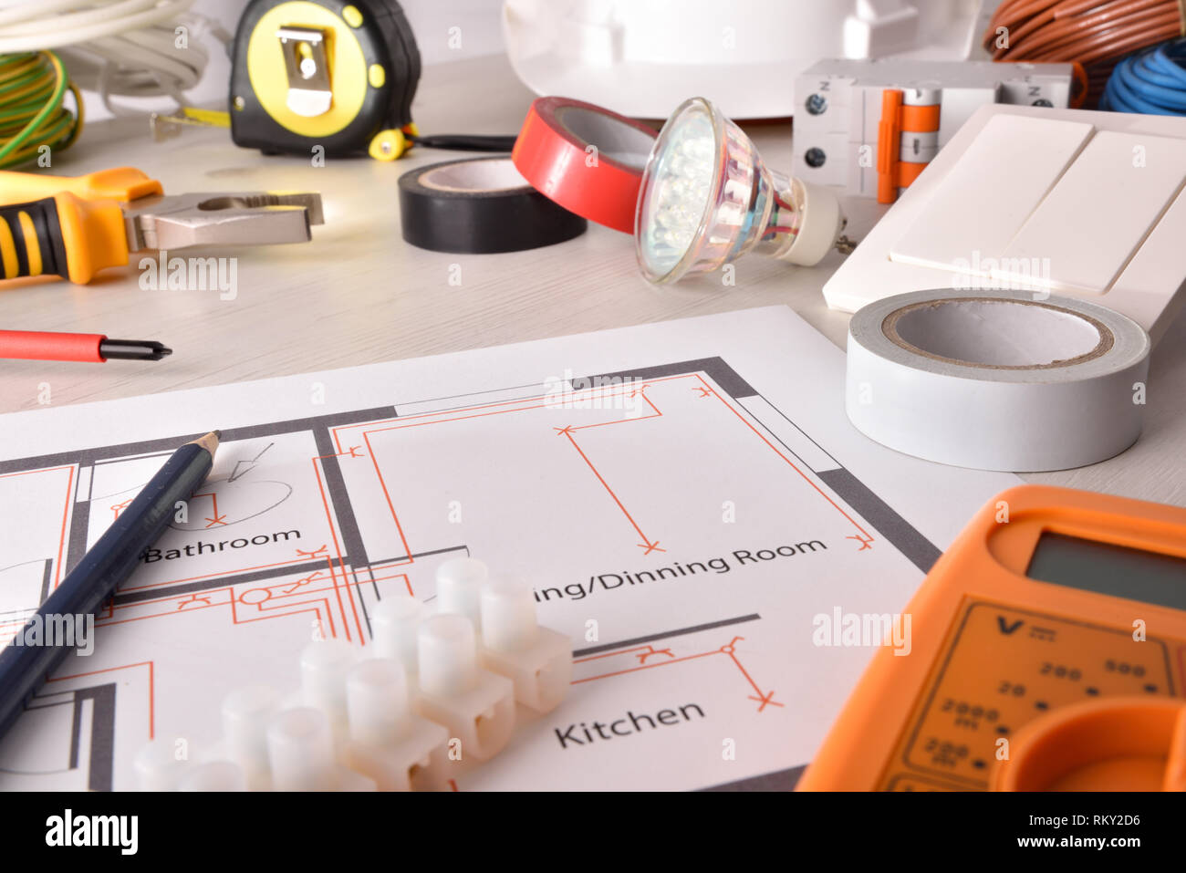 Office table of electrical engineer with installation project and tools ...
