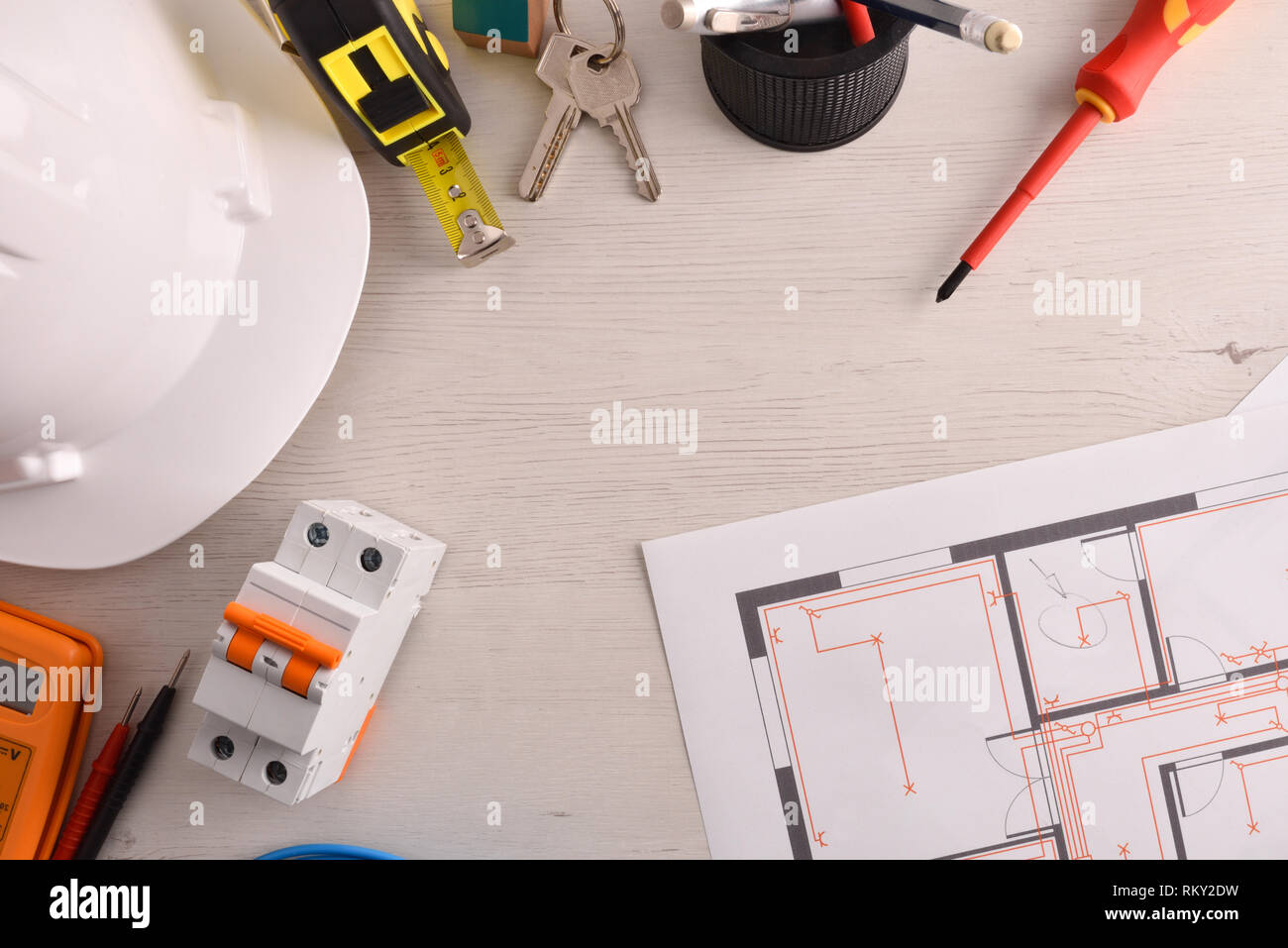 Office table of electrical engineer with installation project and tools ...