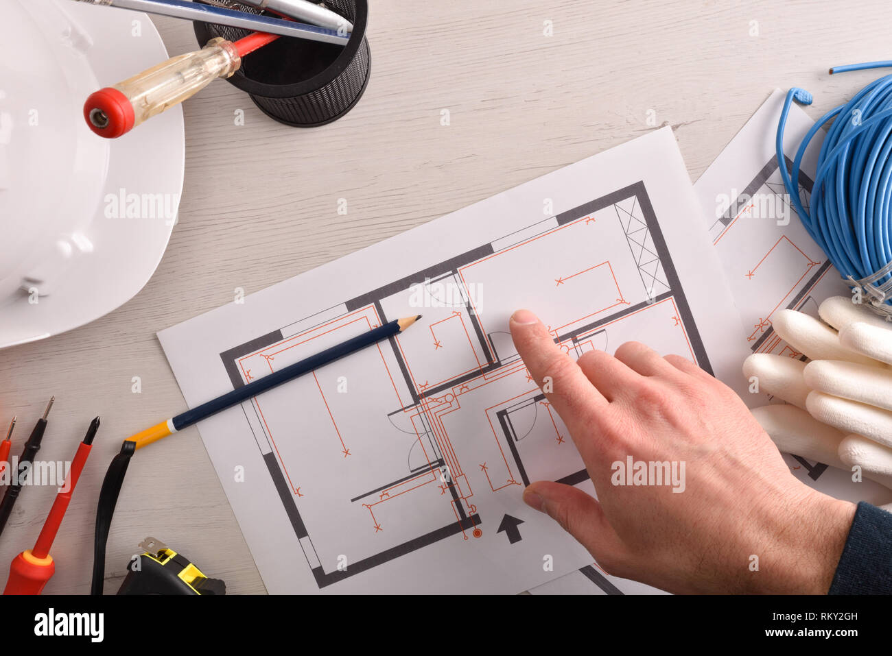 Technical electrician preparing an electrical project of housing in the ...