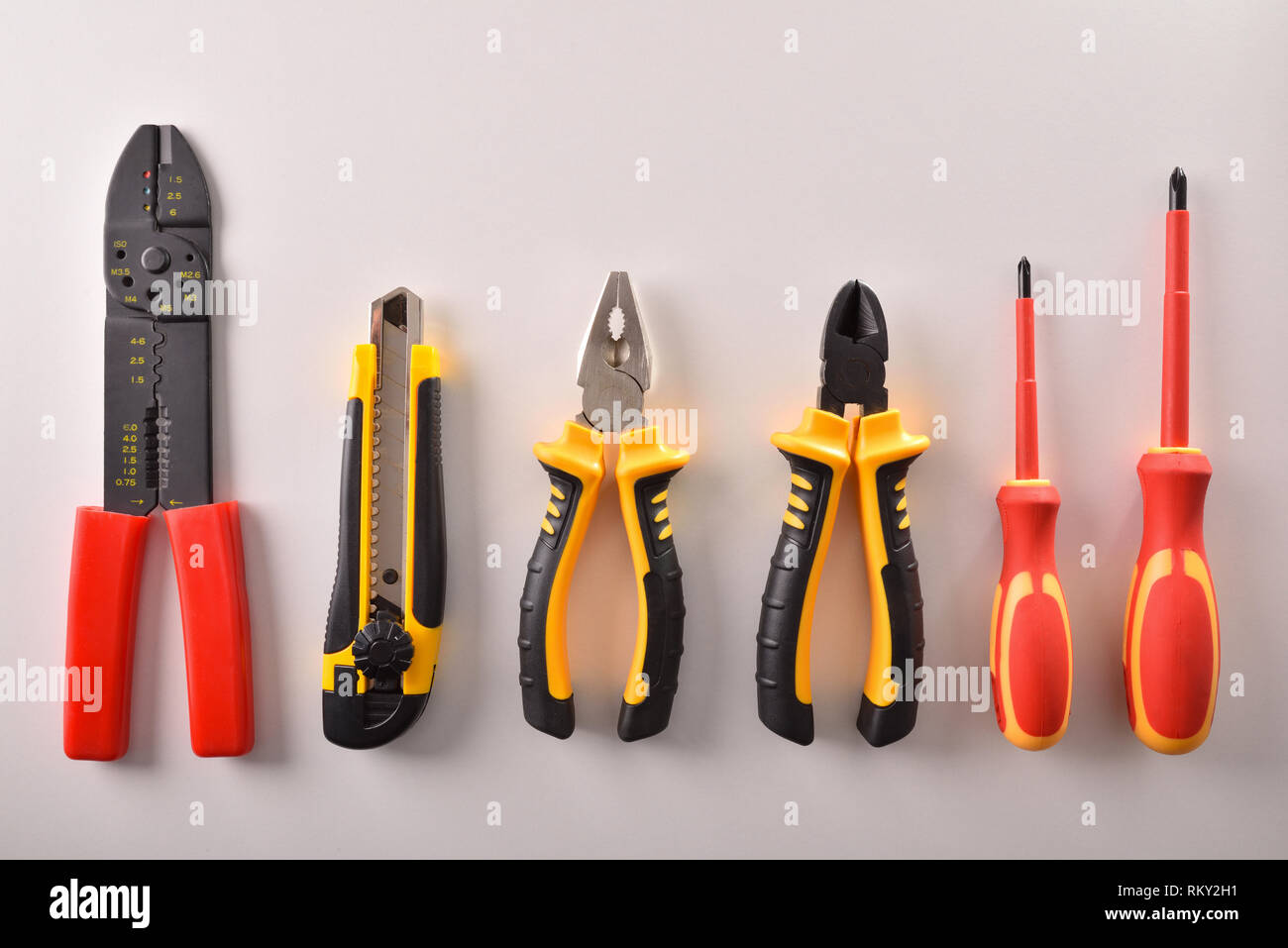 Tools aligned on white table top view. Horizontal composition. Top view ...