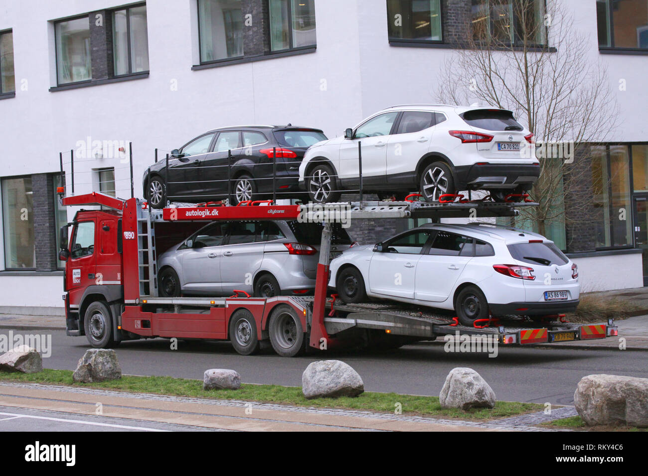Car shipping auto transport vehicle with cars loaded driving in front ...